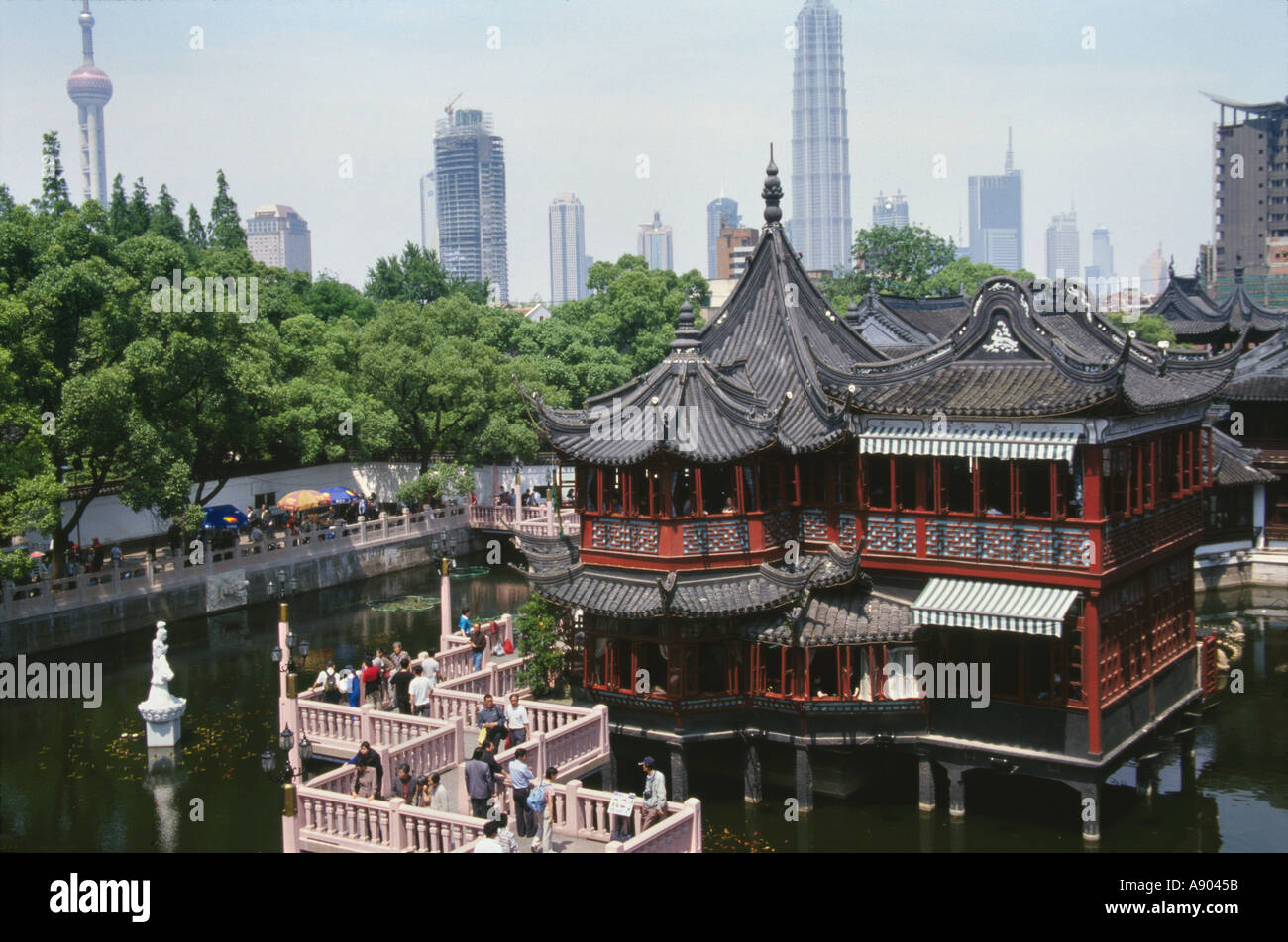 Bridge and pavilion in the Yuyuan Garden highrises and Oriental Pearl ...