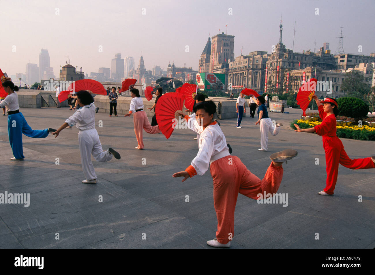 Women dancing with red fans on the Bund in the morning Shanghai China ...