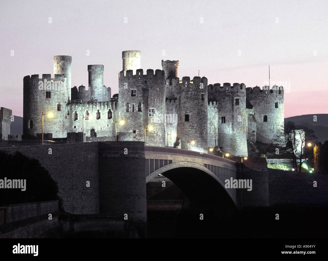 Historical Conwy castle dusk floodlighting illuminating stone walls ...