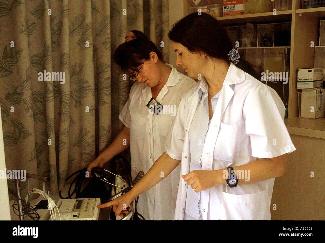 two female nurses discussing patients chart Stock Photo - Alamy
