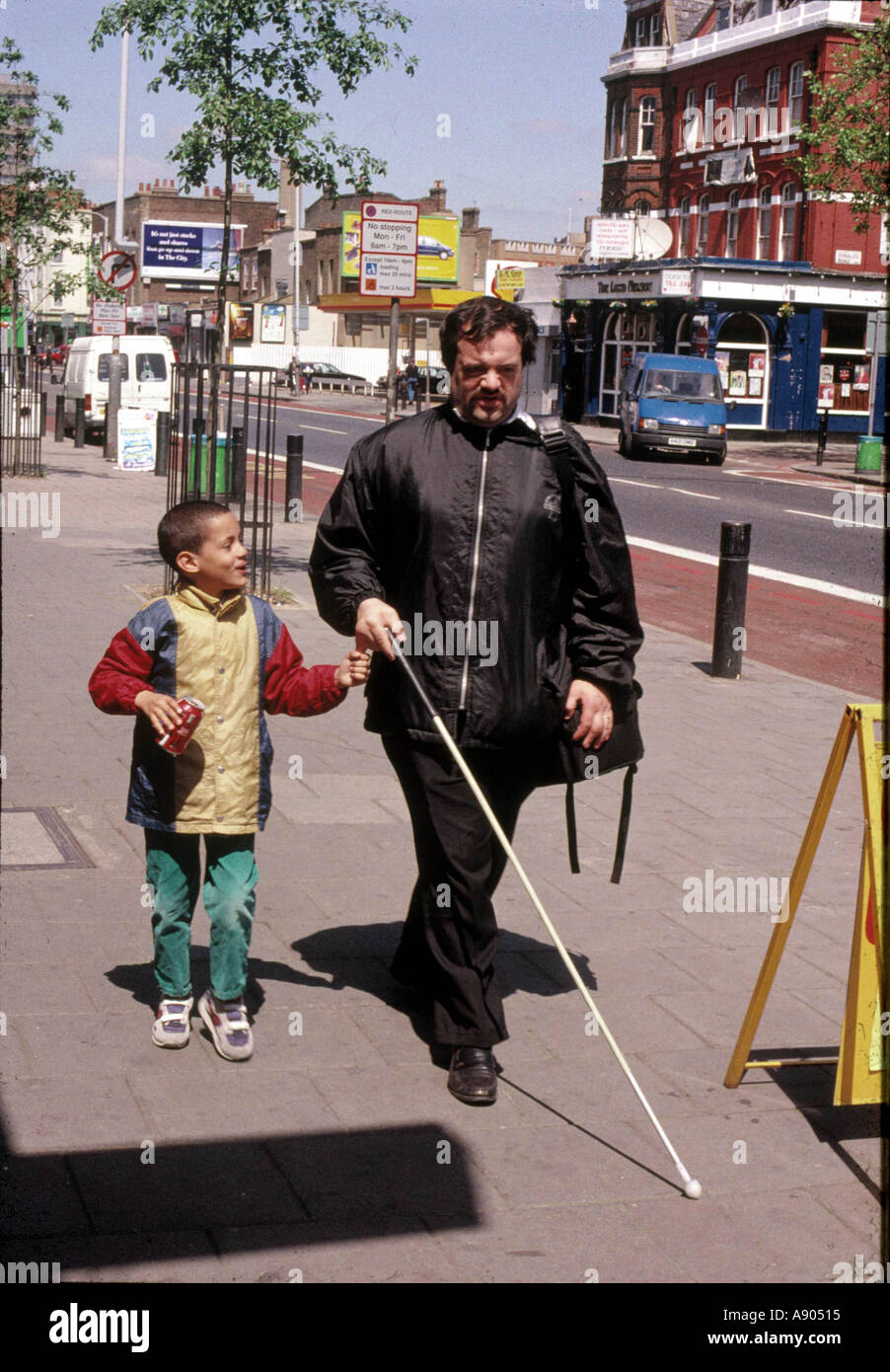 blind father and son walking street Stock Photo - Alamy