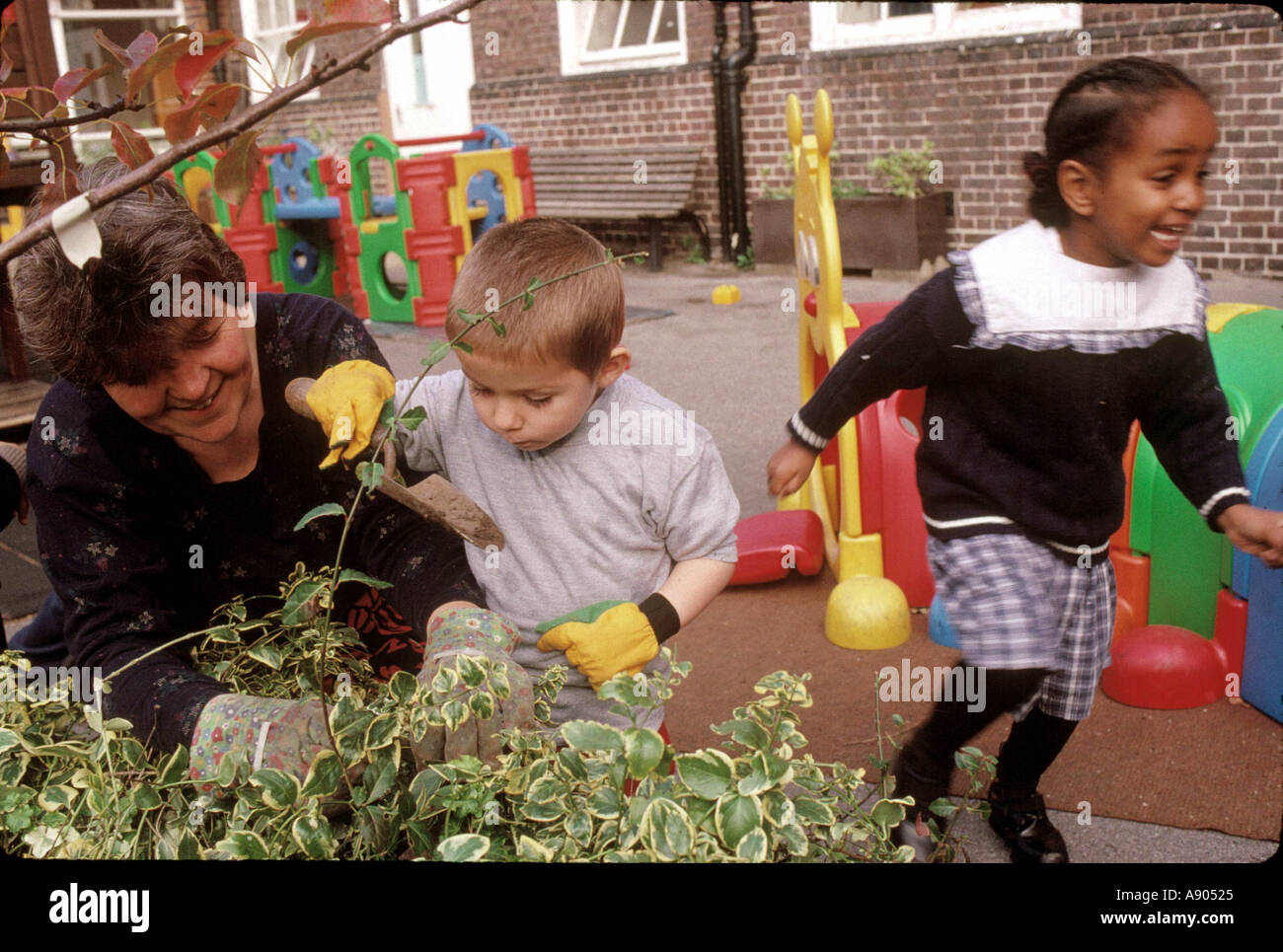 nursery school children digging garden Stock Photo - Alamy