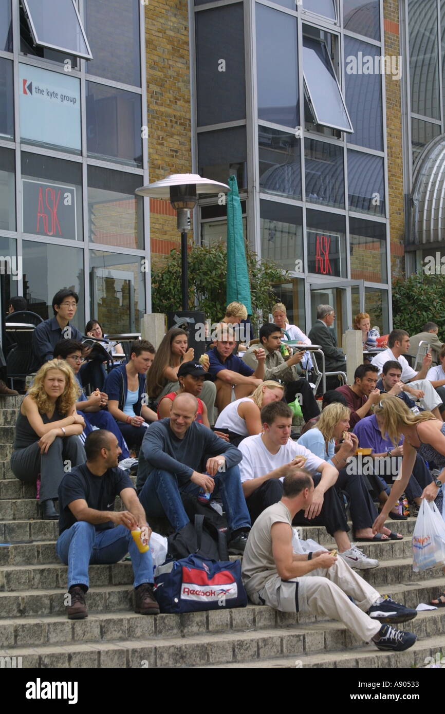students sitting outside steps of college Stock Photo - Alamy