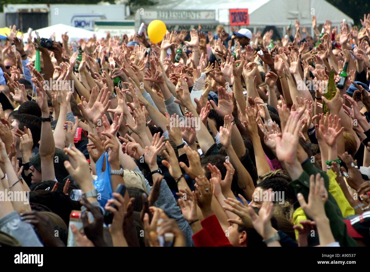 crowd of people at event waving Stock Photo - Alamy