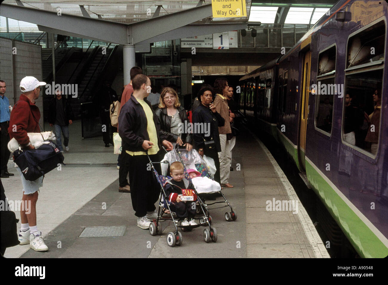 People with children waiting on outside train platform Stock Photo - Alamy