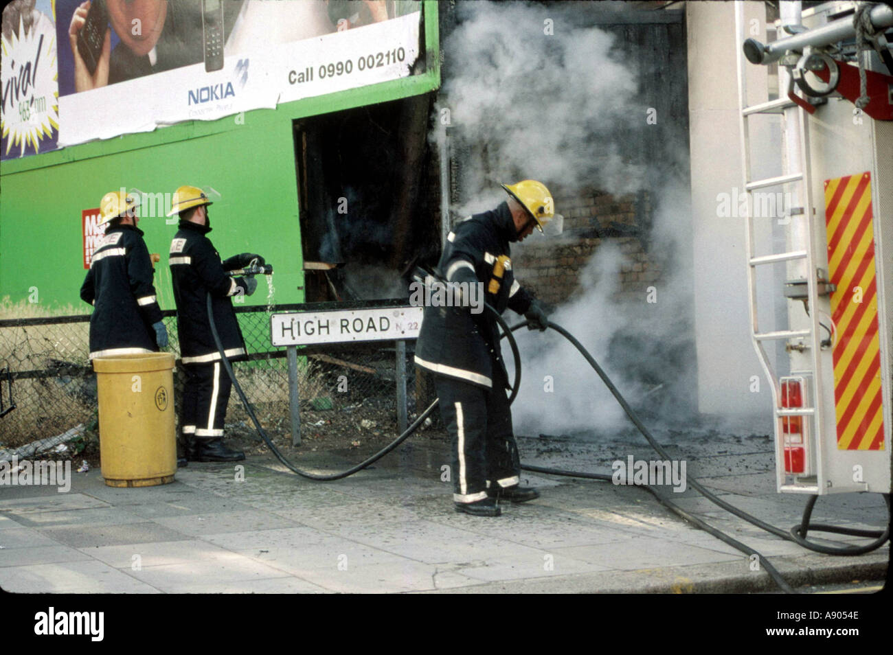 firemen extinguishing fire Stock Photo - Alamy