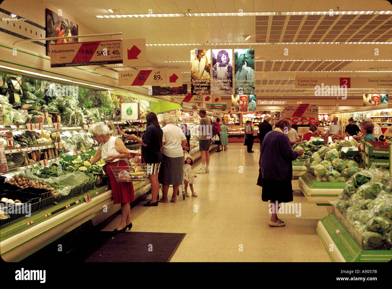 Inside supermarket produce section with people shopping Stock Photo - Alamy