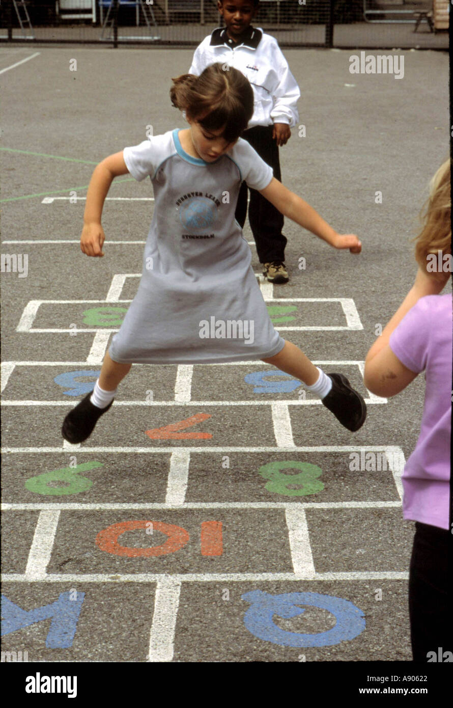 Children playing hopscotch in school playground Stock Photo - Alamy
