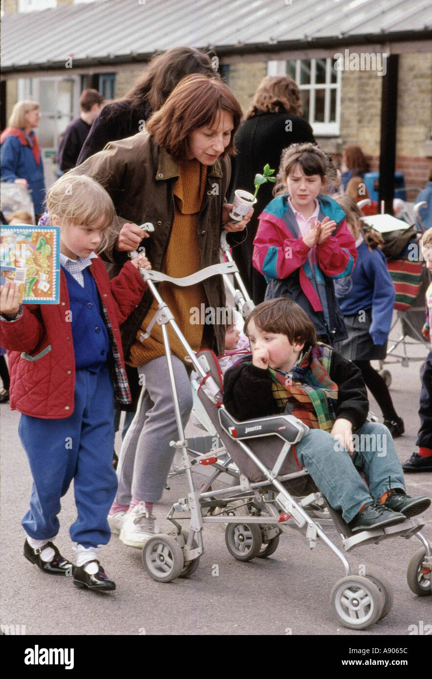 Mother collecting children from school Stock Photo - Alamy
