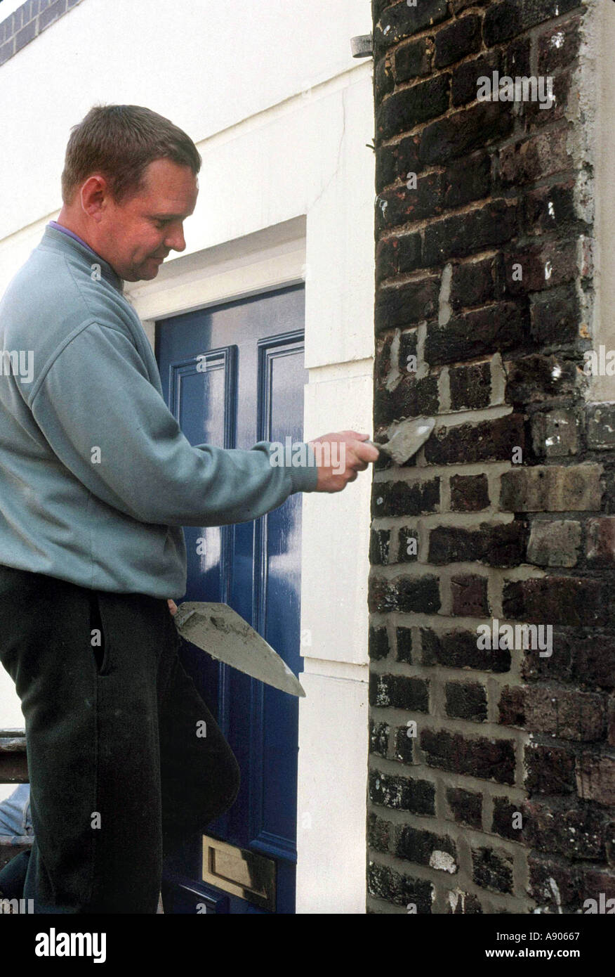Builder repointing brickwork Stock Photo - Alamy