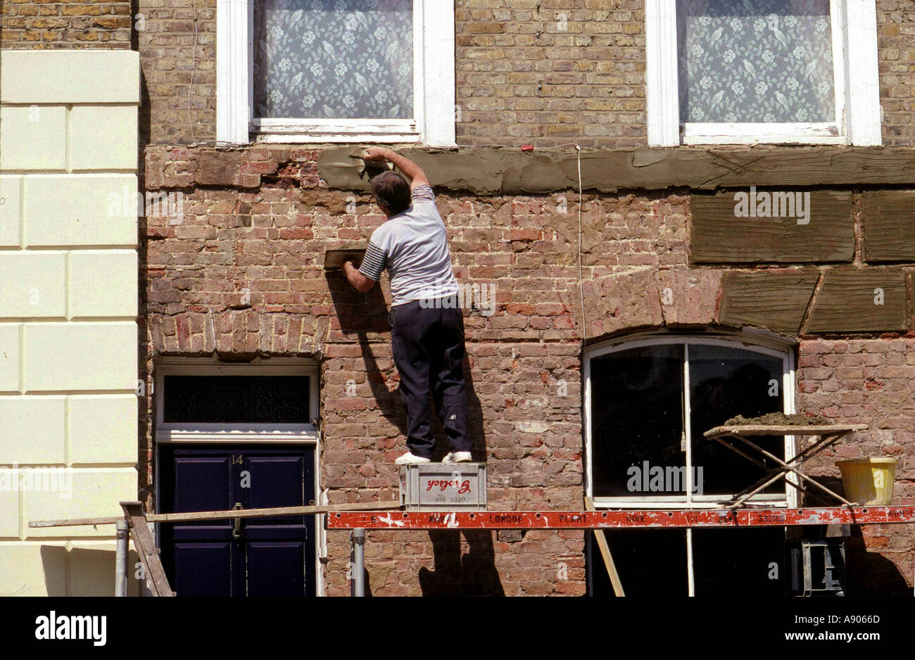 Builder plastering exterior of house Stock Photo - Alamy