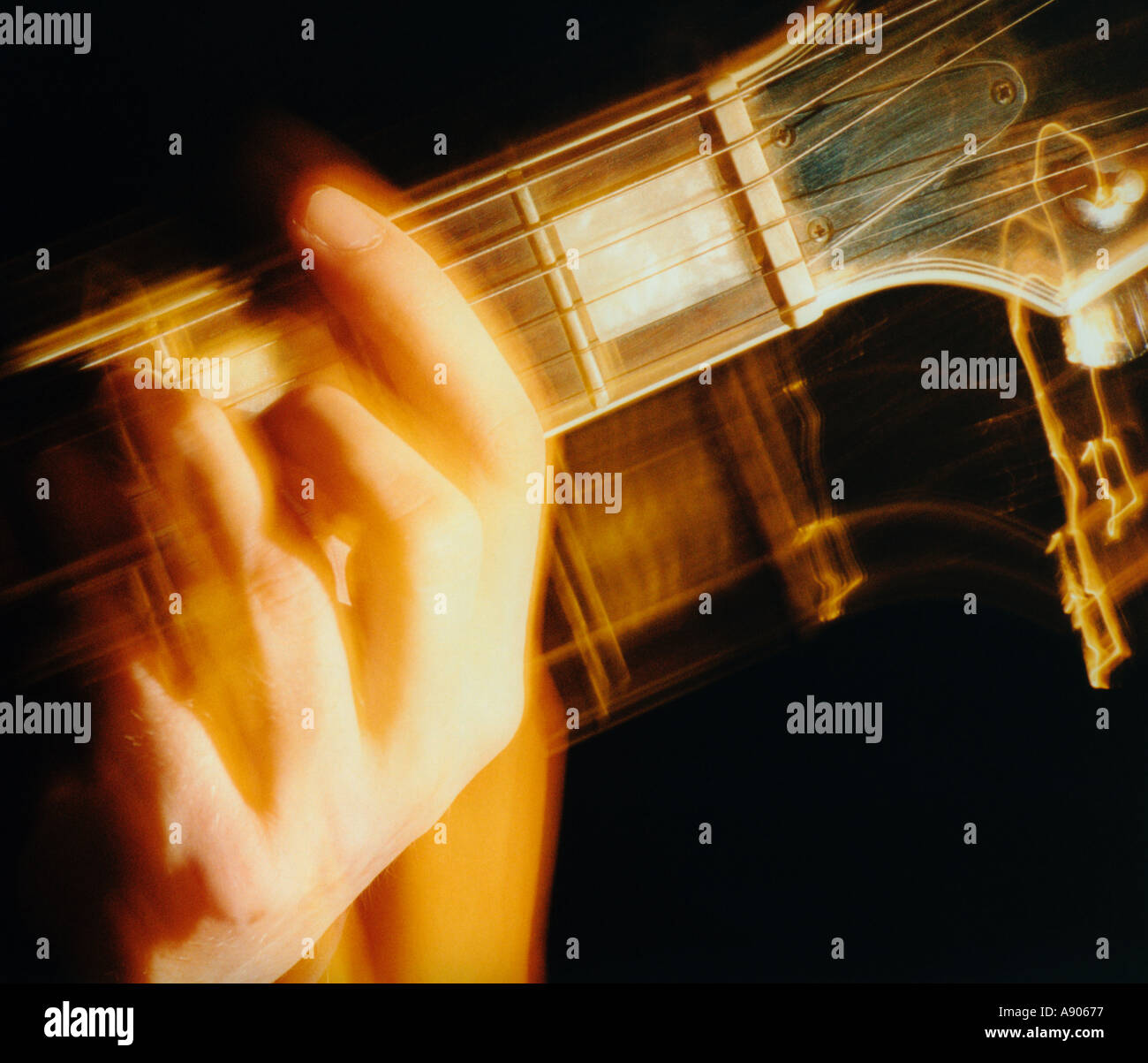 Hand playing guitar chord with movement Stock Photo - Alamy