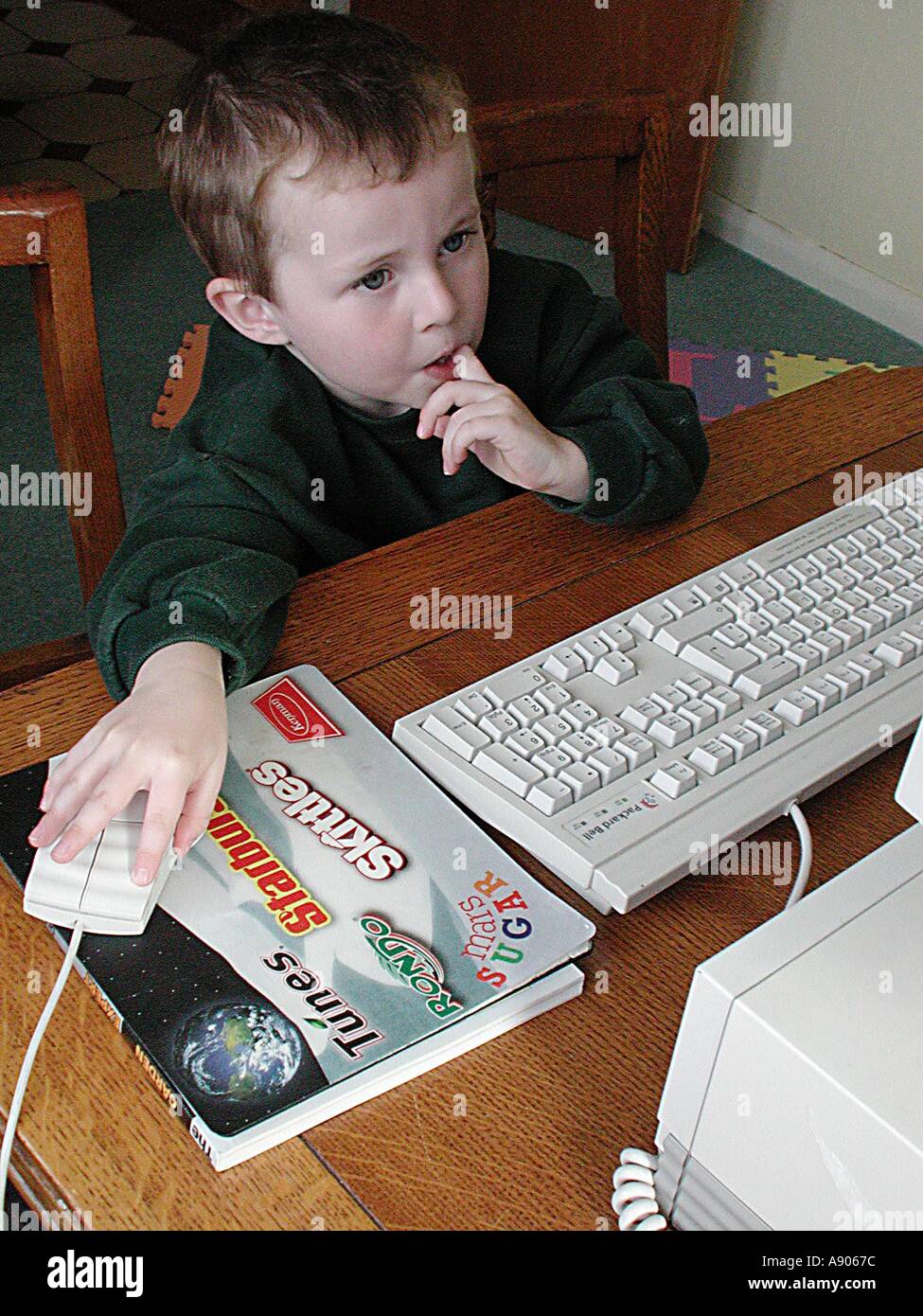 Young boy using a computer Stock Photo - Alamy