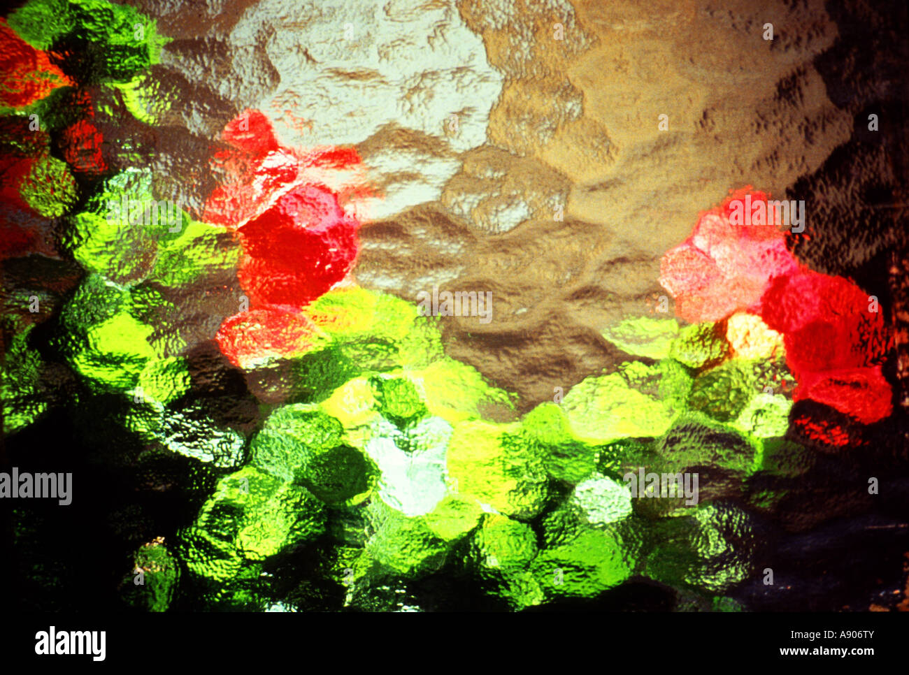 Impressionist conceptual picture of geraniums through contoured glass ...