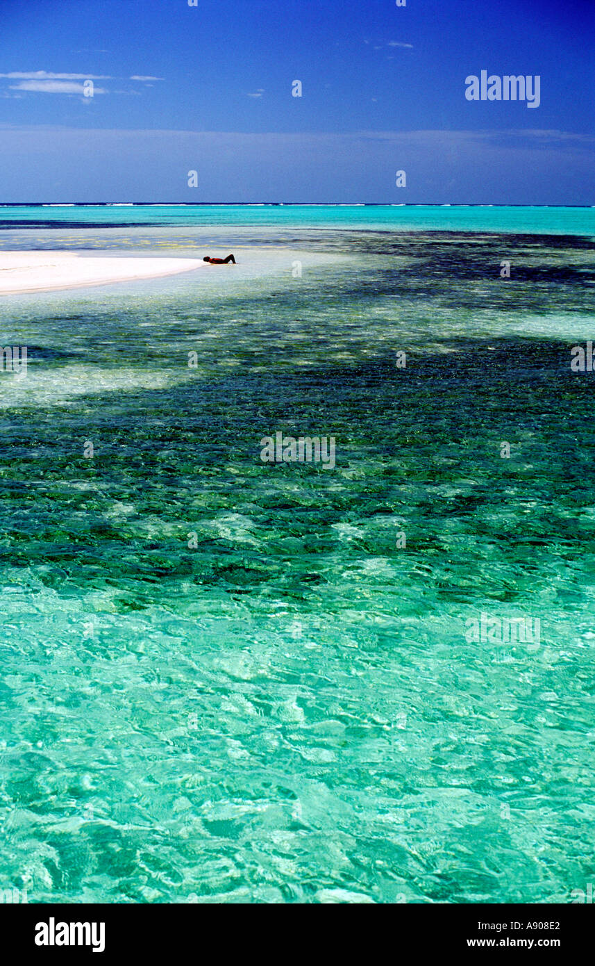 Sunbathing on a sand spit on Owen Islands by the lagoon Little Cayman ...