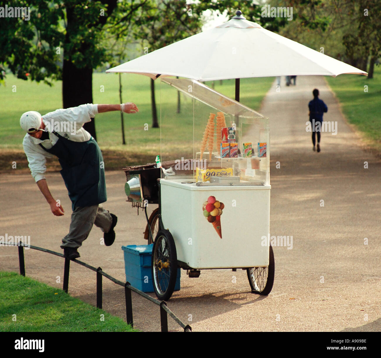 Ice cream seller walking on railing Kensington Gardens London England ...