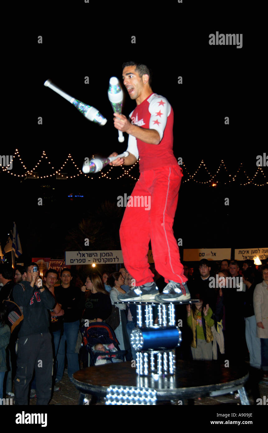 A man juggling while balancing on a tube Stock Photo - Alamy