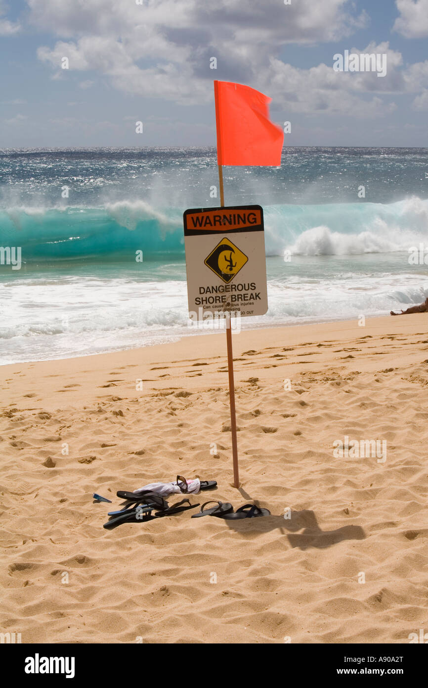 Dangerous shore break warning sign at Sandy Beach, Oahu, Hawaii, with a ...