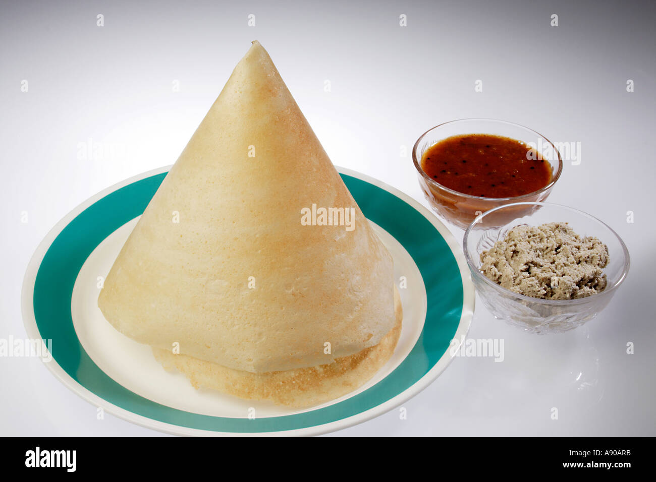 VDA78032 Indian snack food dosa in cone shape on a plate with chutney ...