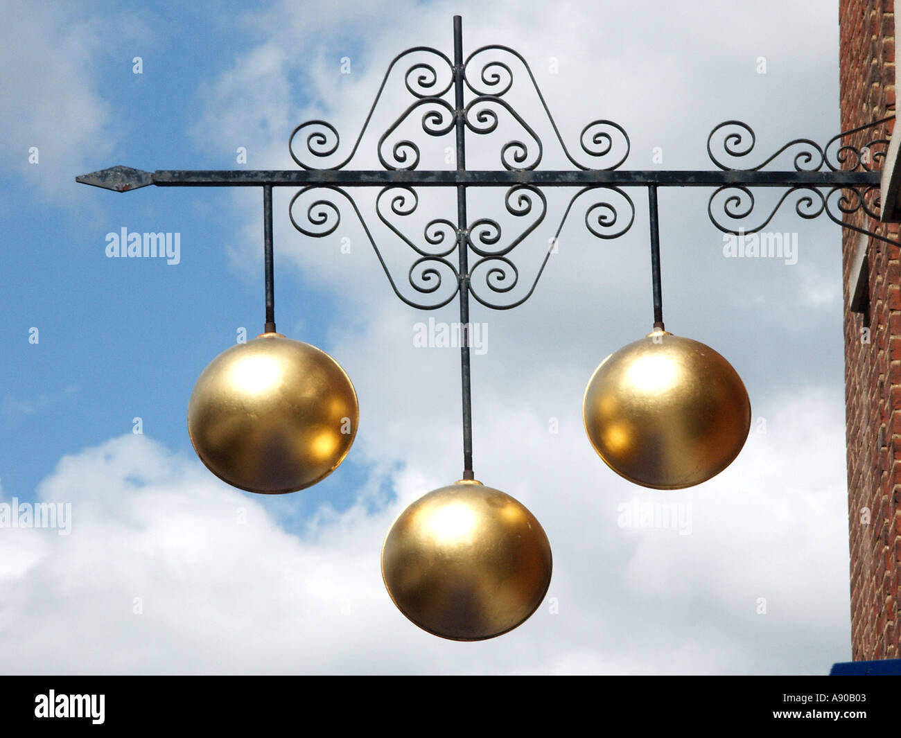Pawn shop close up of traditional sign of three gold balls above ...
