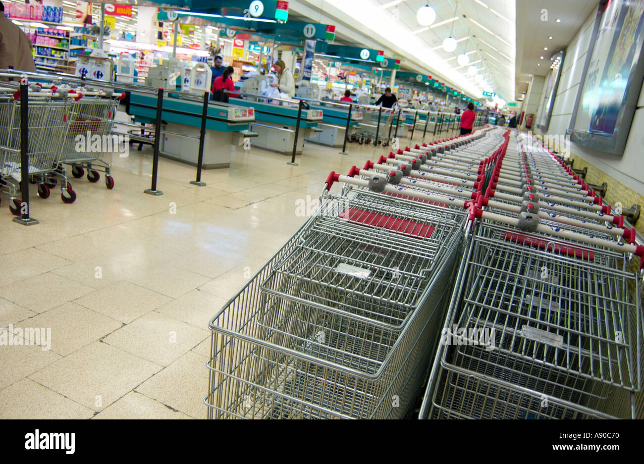 shopping carts and cashiers at a supermarket Stock Photo - Alamy