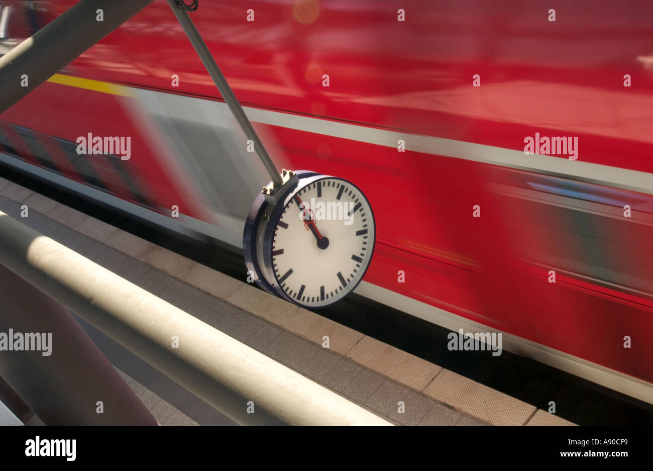 train pulling out of station at exactly 12 noon Stock Photo - Alamy