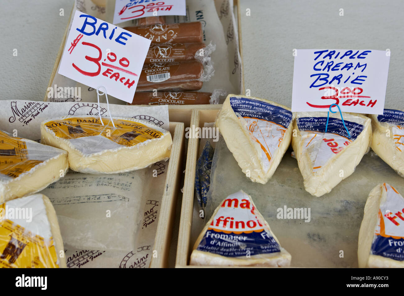 MASSACHUSETTS Boston Wedges of brie cheese for sale signs with prices ...