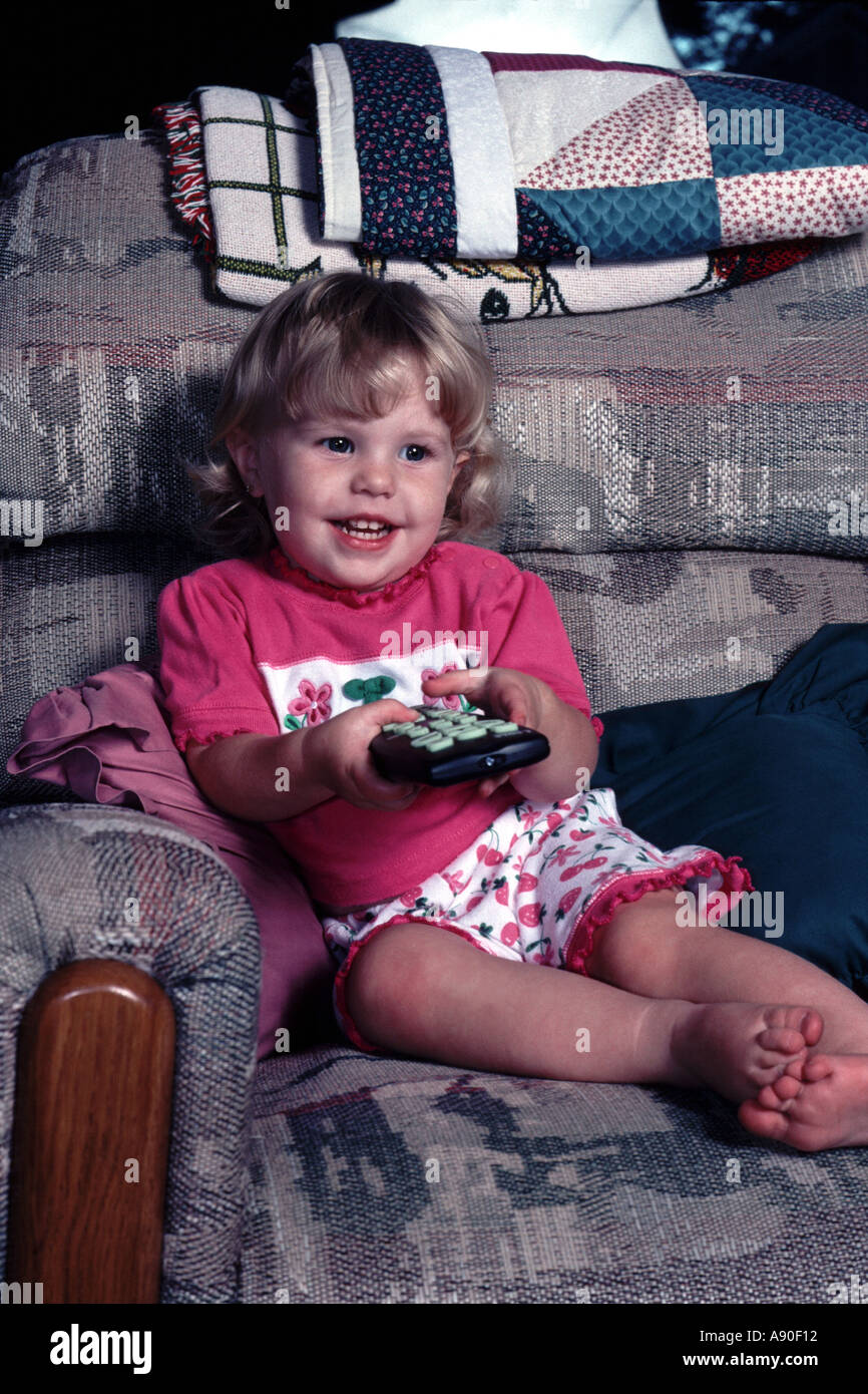 Child using TV remote controller Stock Photo - Alamy