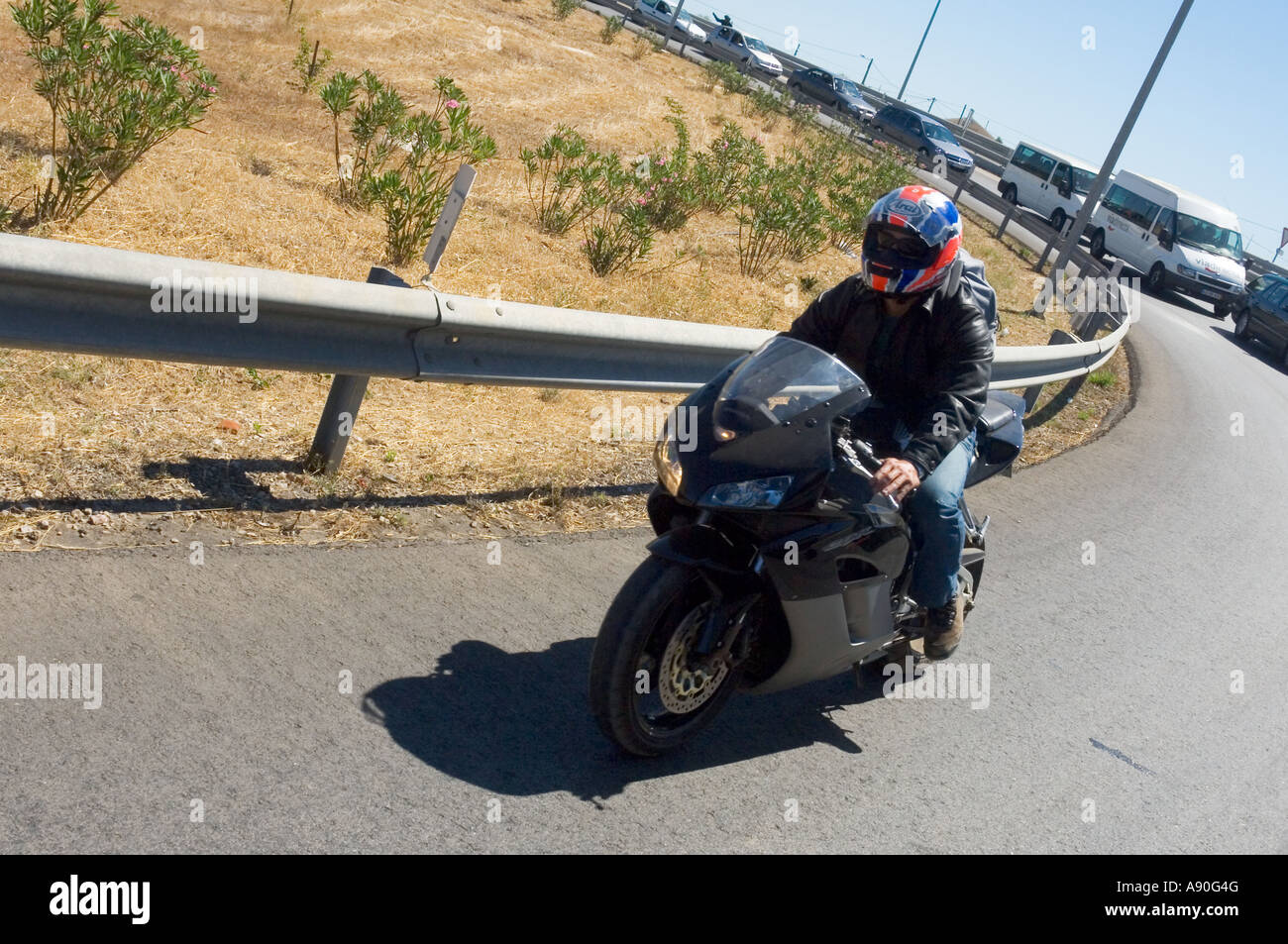 A biker leaving the Motorcycle Rally Faro Algarve Portugal Stock Photo ...