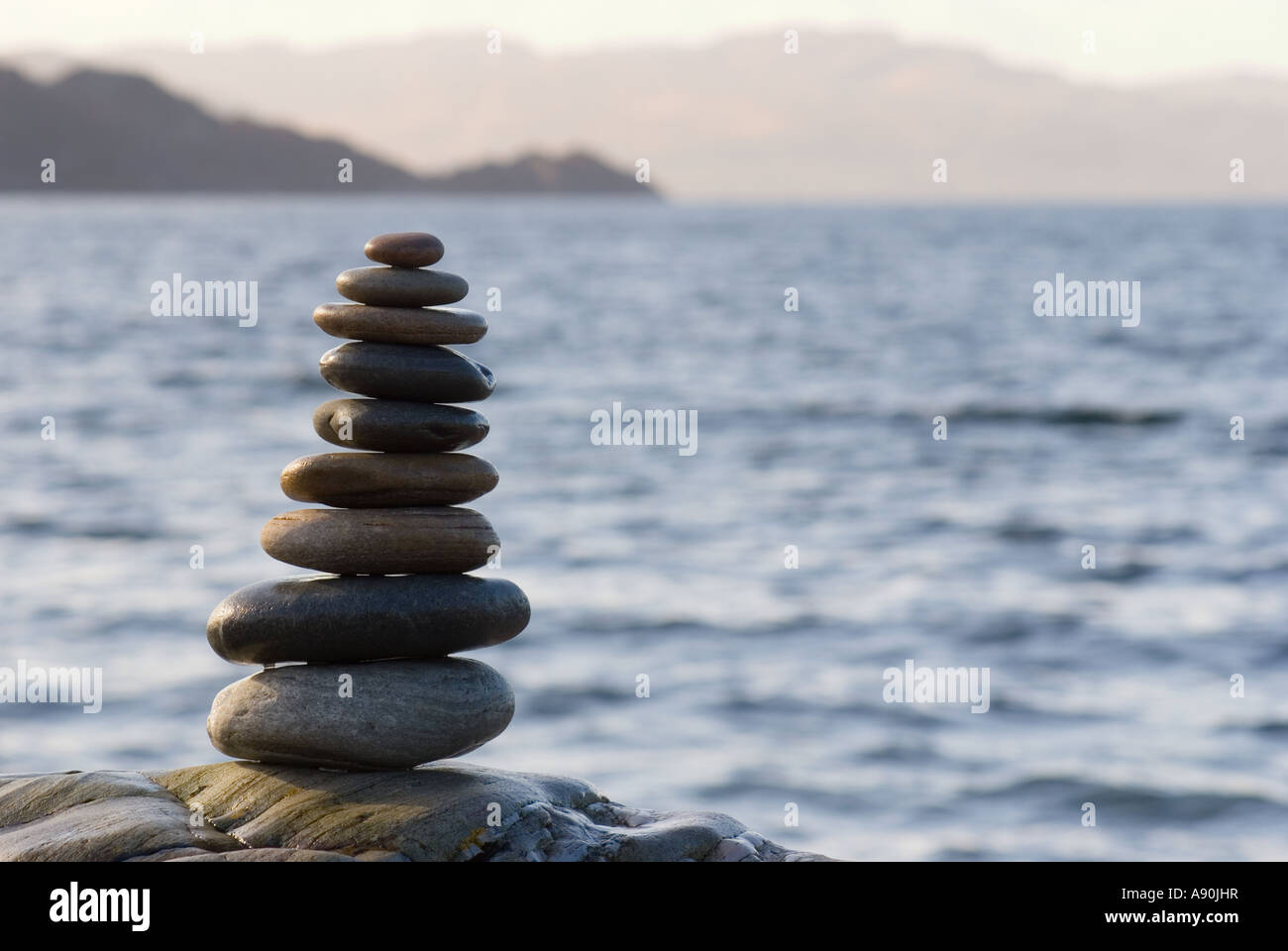 Beautifully smooth pebbles and boulders stacked into a cairn create ...