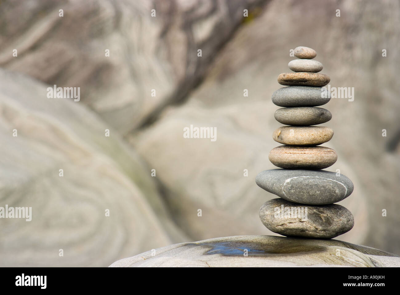 Beautifully smooth pebbles and boulders stacked into a cairn create ...