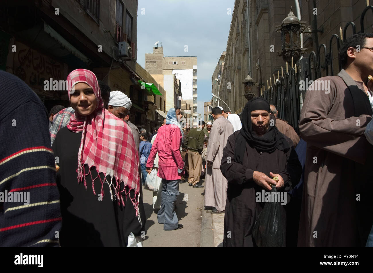people near mosque at prayer time street scene Islamic Cairo Cairo ...