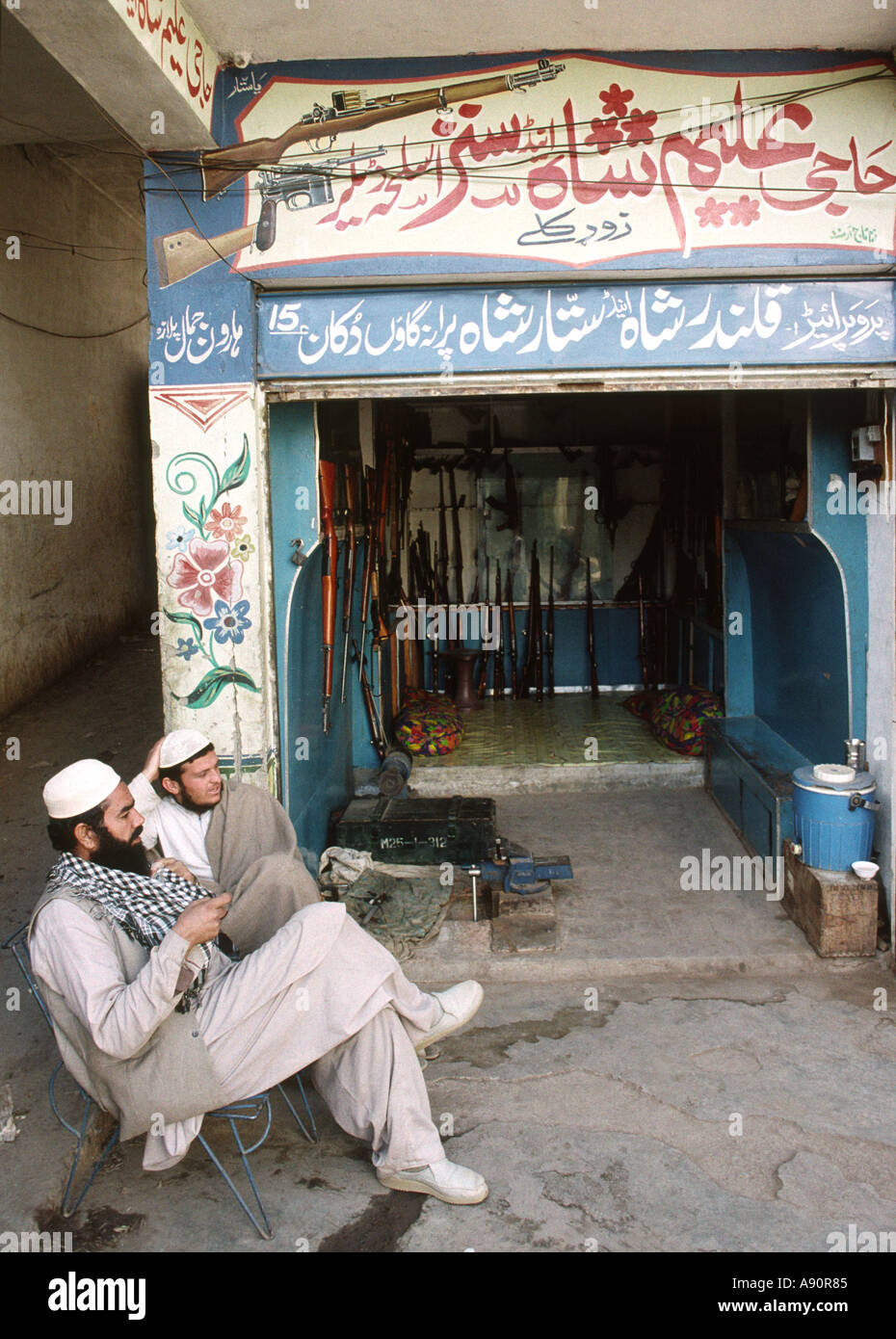 Pakistan NWFP Darra Adam Khel men sat outside gun shop Stock Photo - Alamy