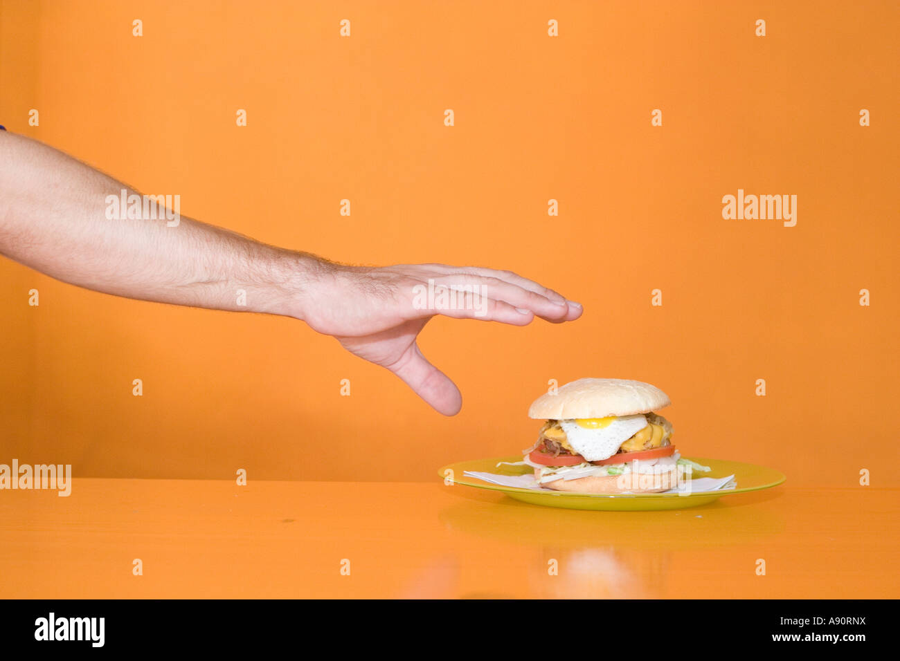 Hand Reaching Out to Homemade Burger Stock Photo - Alamy