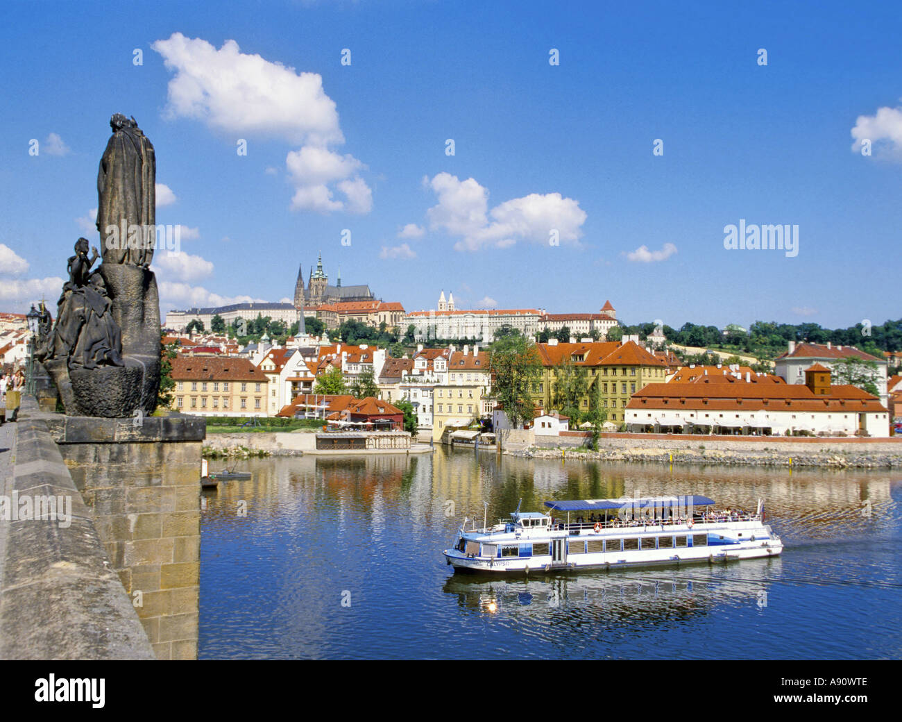 Tourist boat on Vltava River and Castle from Charles Bridge in Prague ...