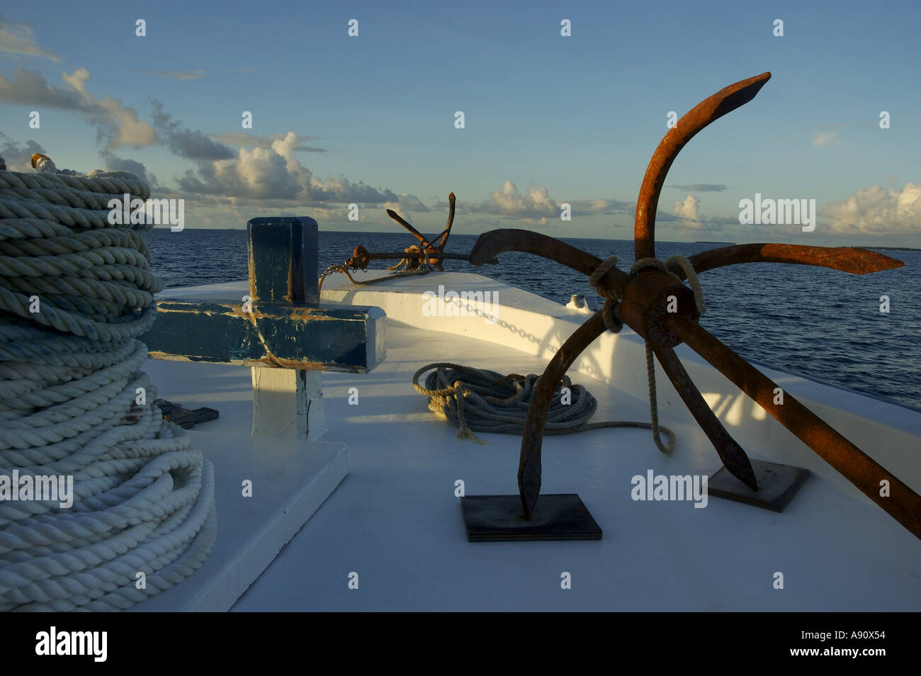 Maldives stack of ropes and rusty anchors on the prow at sunset Stock ...