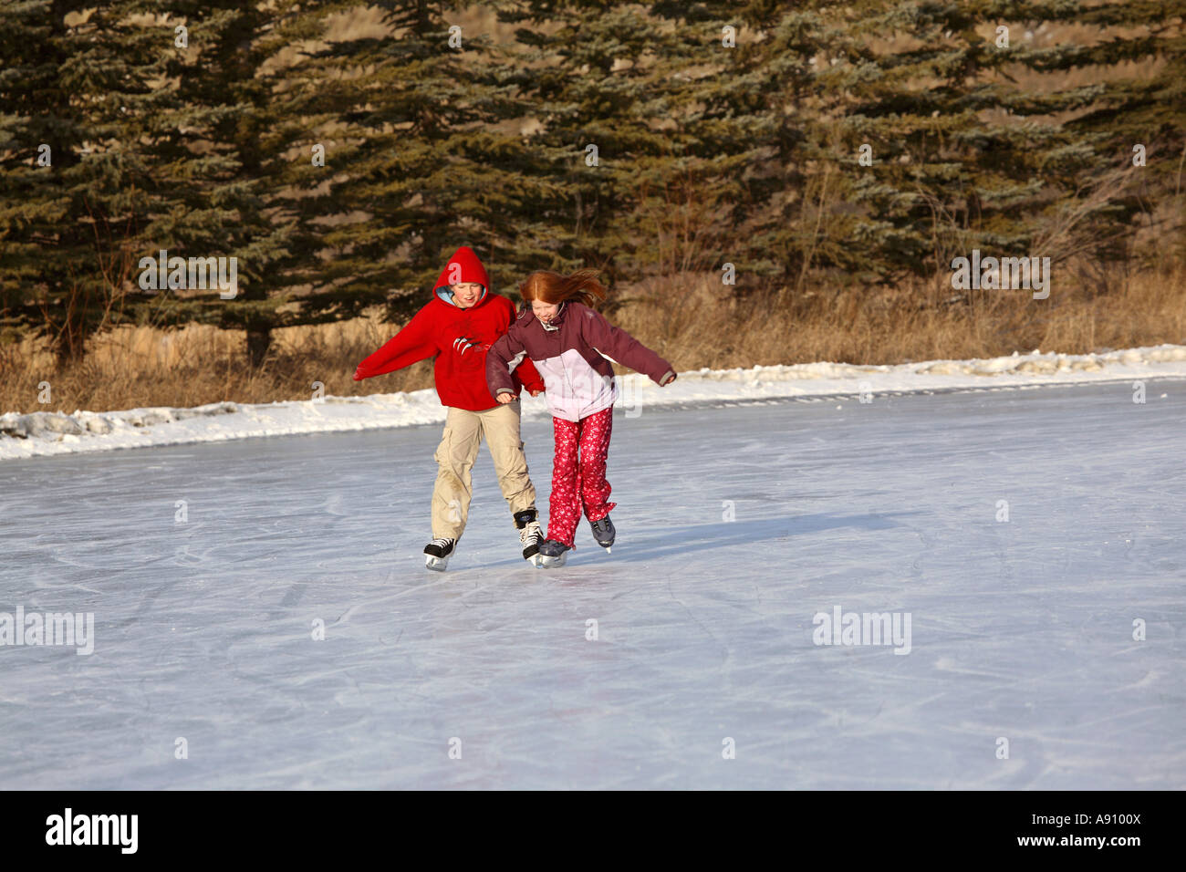 Children skating on outdoor ice in Moose Jaw Stock Photo - Alamy
