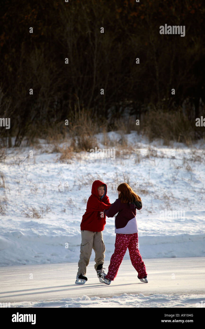 Children skating on outdoor ice Stock Photo - Alamy