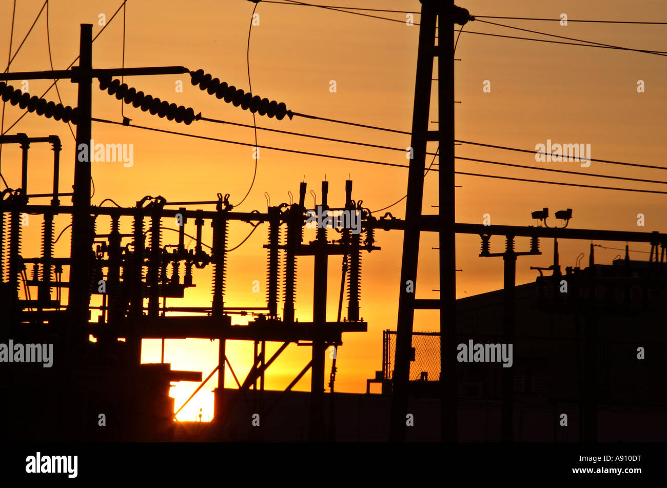 Sun setting behind power transformers Stock Photo - Alamy
