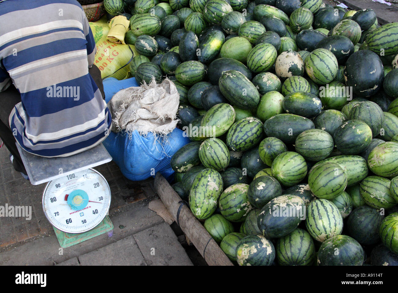 Asia, Cambodia, Kratie, watermelon vendor sits on his scale Stock Photo ...