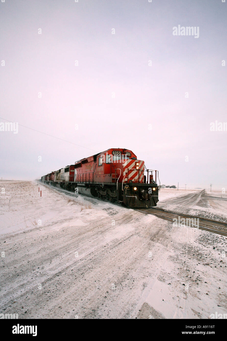 Train approaching road crossing during a Saskatchewan winter Stock ...