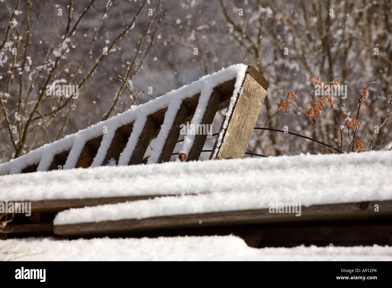 Snow covered boards and railing Stock Photo - Alamy