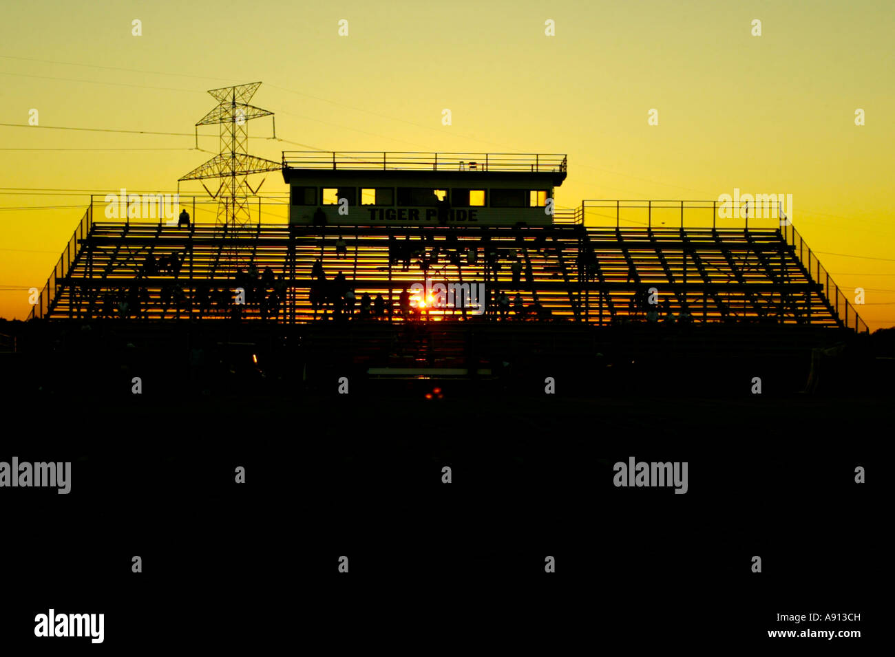 Fans in stadium at sunset Stock Photo - Alamy