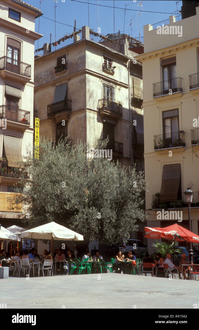 Young people sitting outside cafes summer LOCATION Pla Dr Collado ...