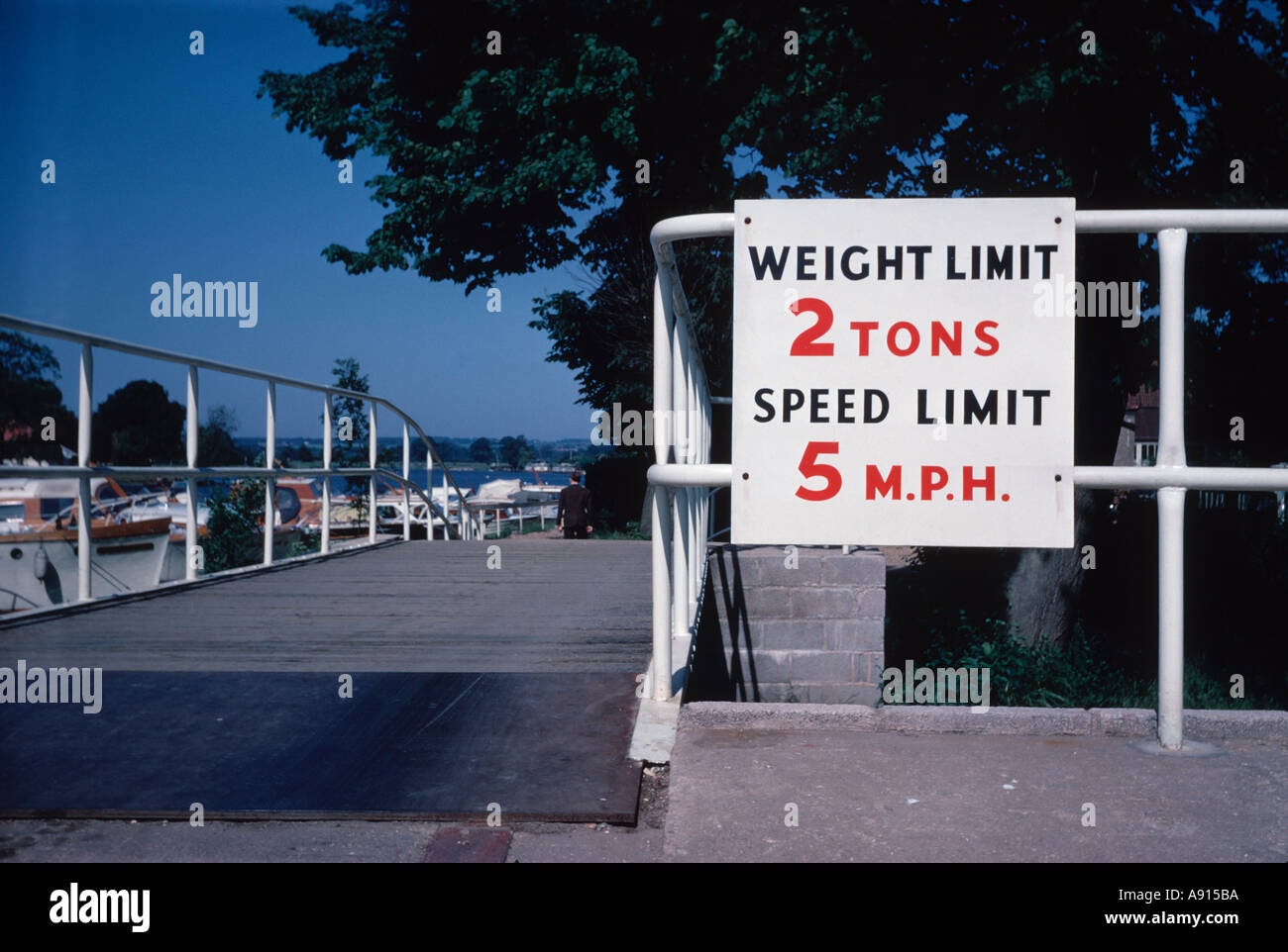 Warning sign on small bridge reading weight limit 2 tons speed limit 5 ...
