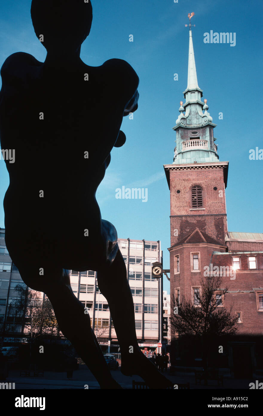 Modern statue and ancient church London England Stock Photo - Alamy