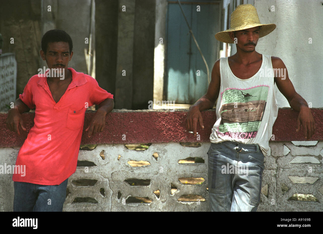 Two Cuban farm men hanging out in shade at market in Sierra Maestra ...