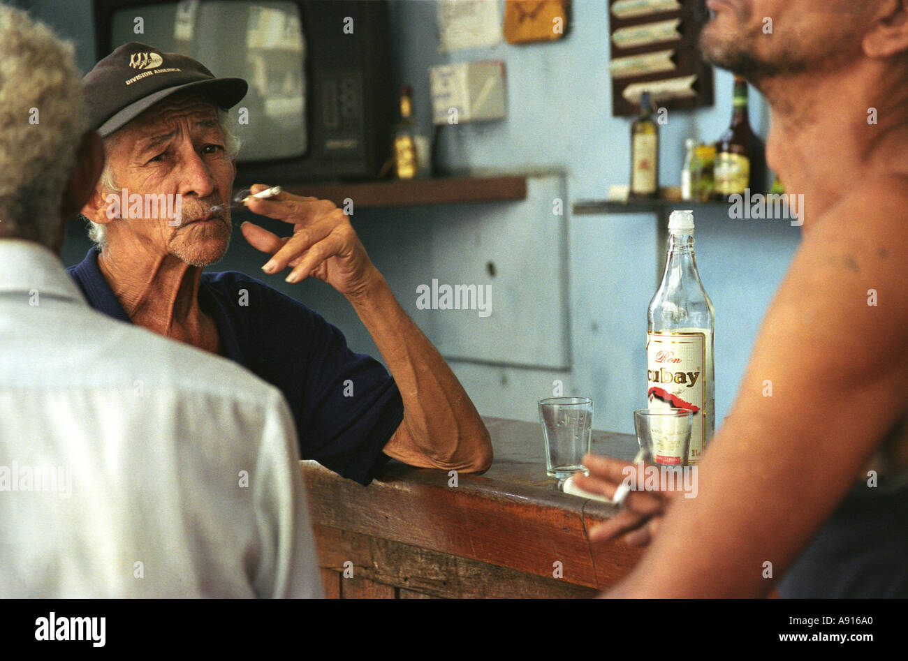 Old Cuban guy drinking rum in open front bar in Central havana cuba ...