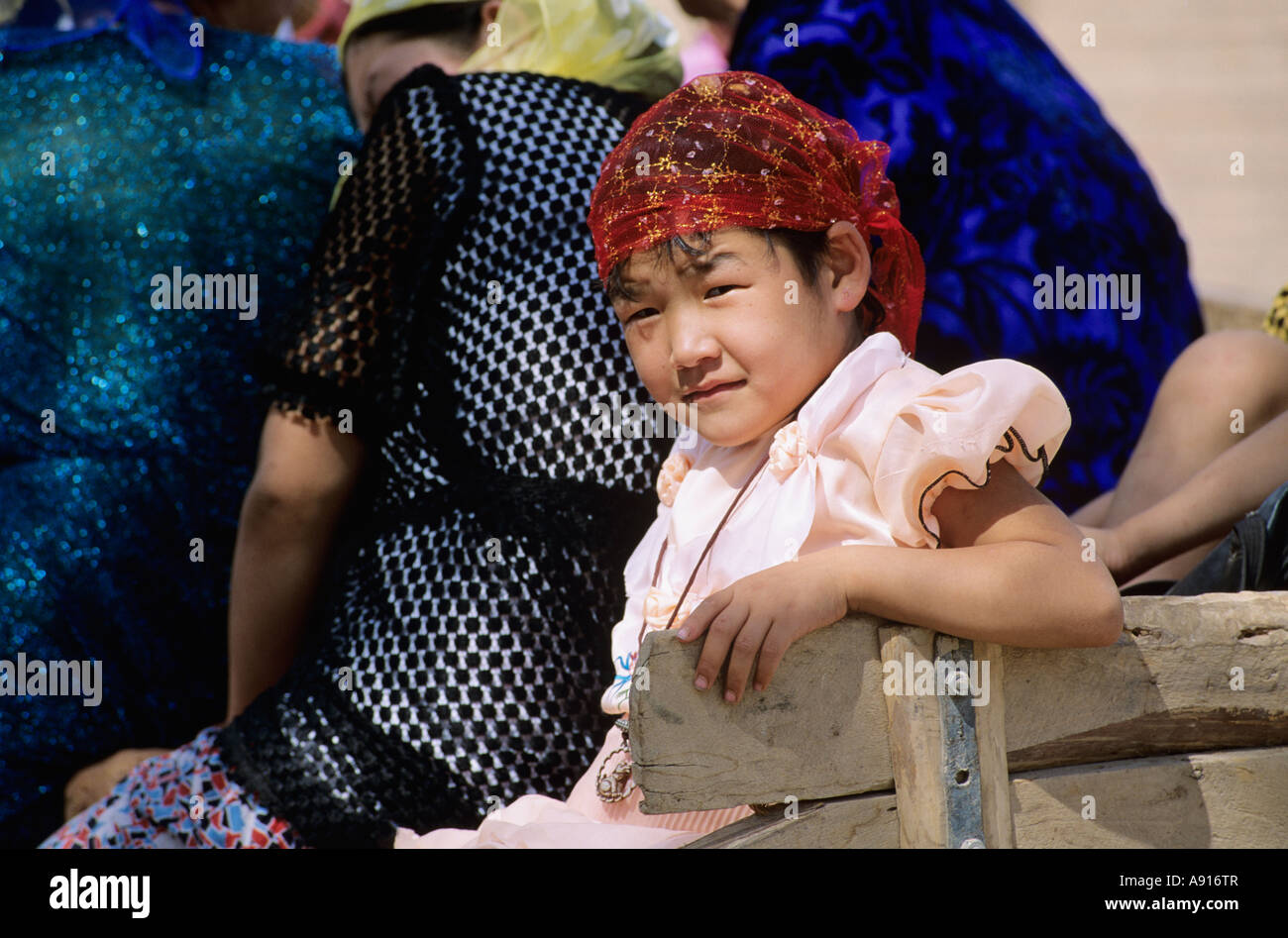 Girl sitting on wagon, Turpan, Xinjiang Province, China Stock Photo - Alamy
