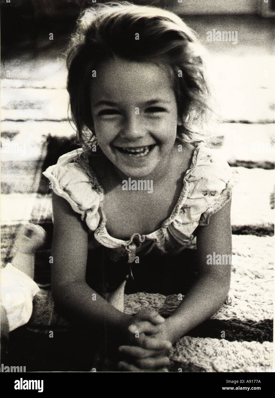 Pretty little girl smiles happily for the camera Stock Photo - Alamy